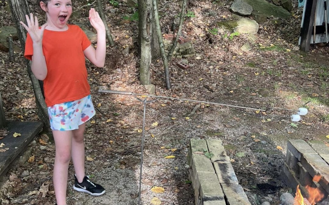 little girl hand up campfire creation | Visit PA Great Outdoors